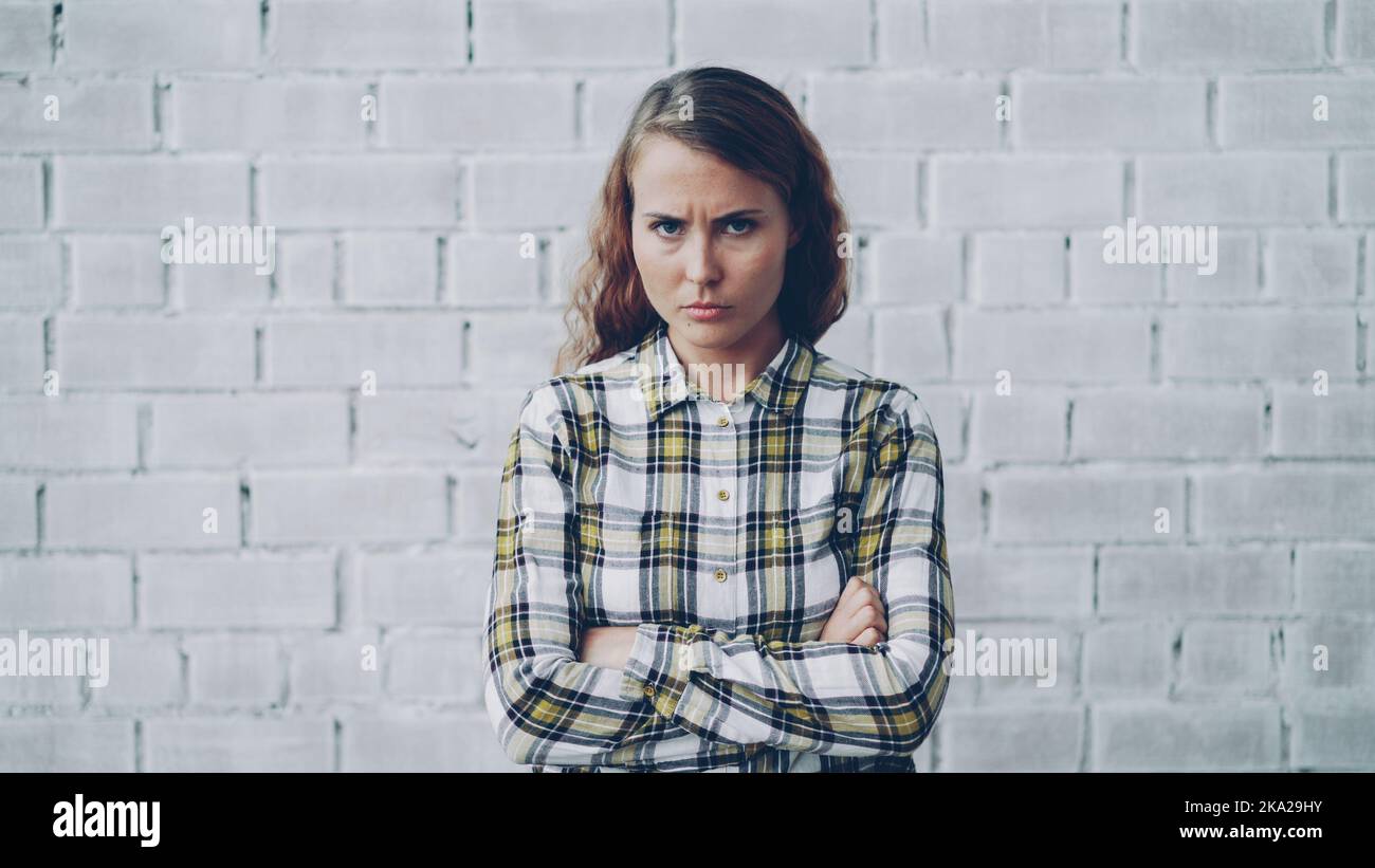 Portrait of angry young lady looking at camera, frowning and shaking ...