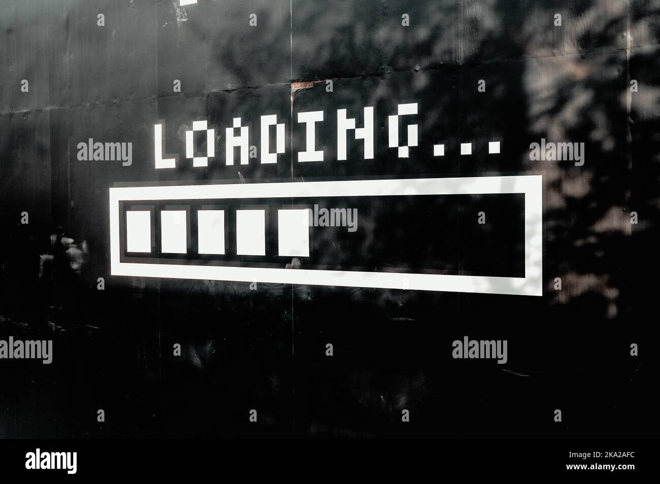 A black wall with loading icon painted Stock Photo - Alamy