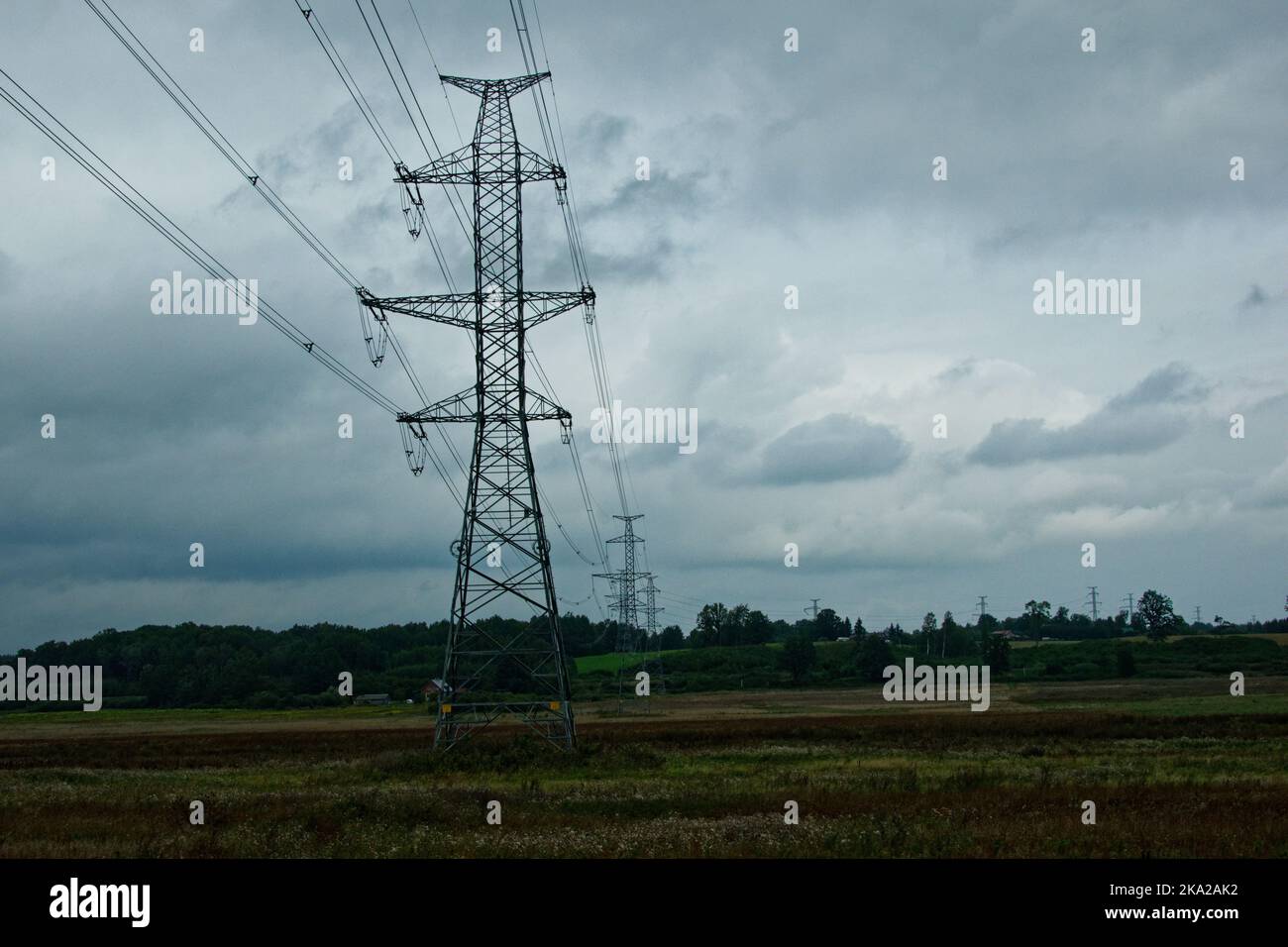 An electric power masts and cables on a cloudy day Stock Photo - Alamy