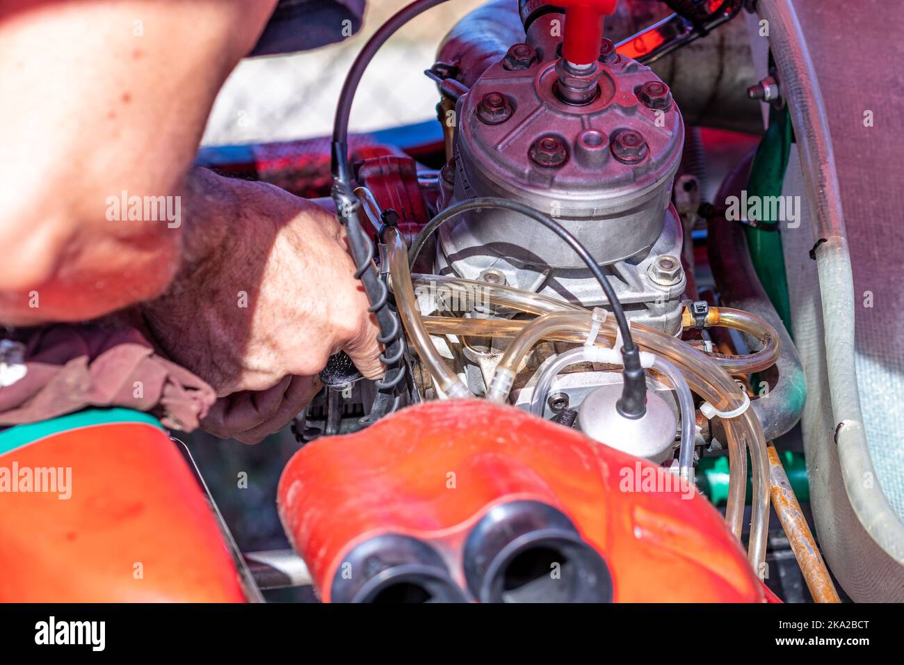 A closeup of a kart mechanic fixing an engine in a race Stock Photo - Alamy