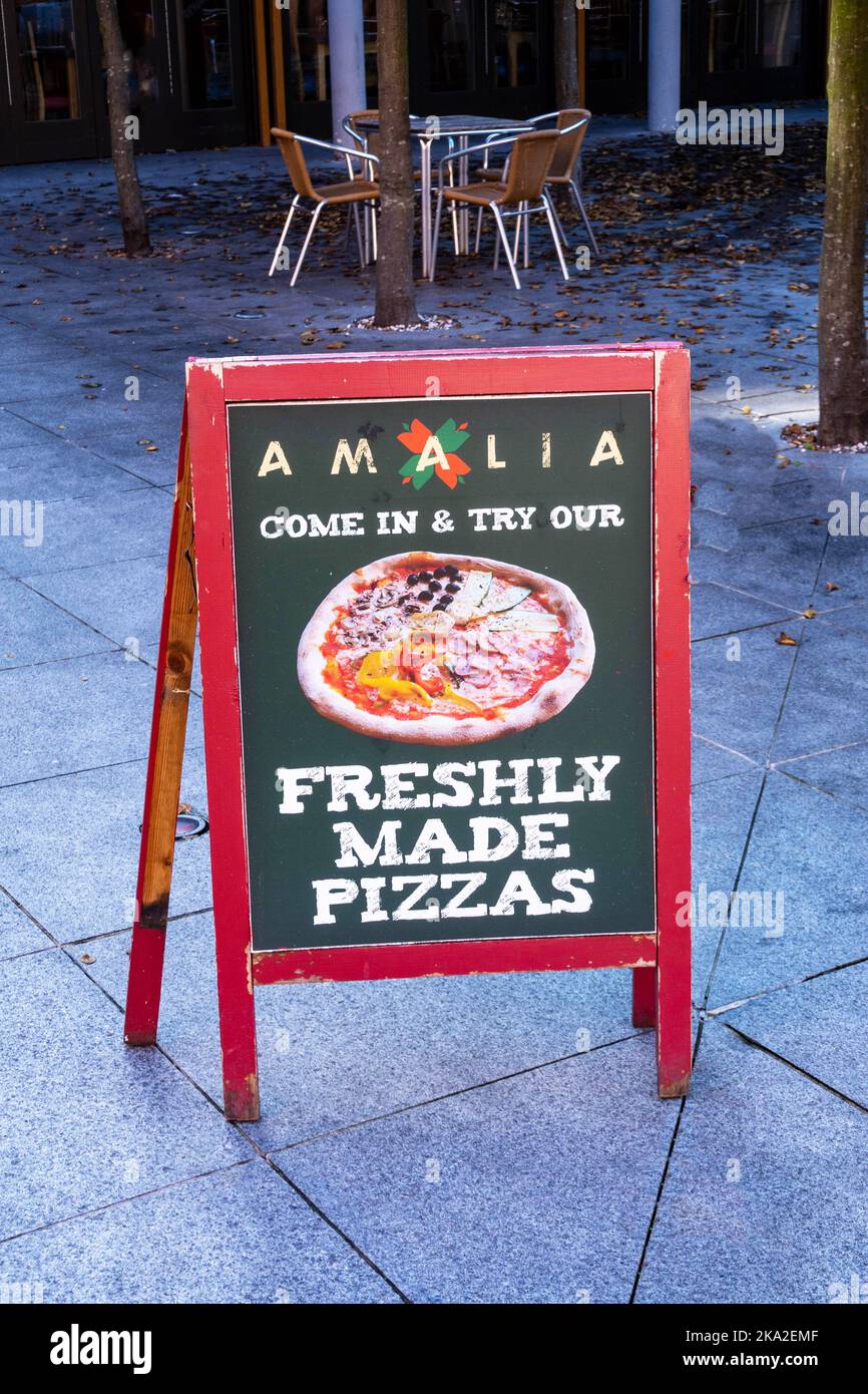 Street board sign advertising pizza outside Amalia restaurant in ...