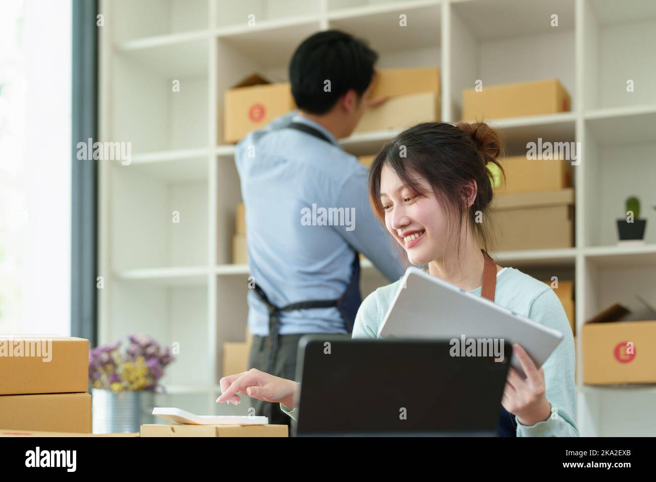 Portrait of a small start-up and SME owner, an Asian male and female ...