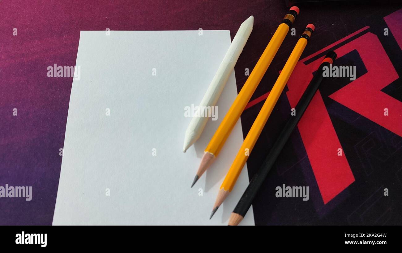 A white paper with pencils for sketching Stock Photo - Alamy