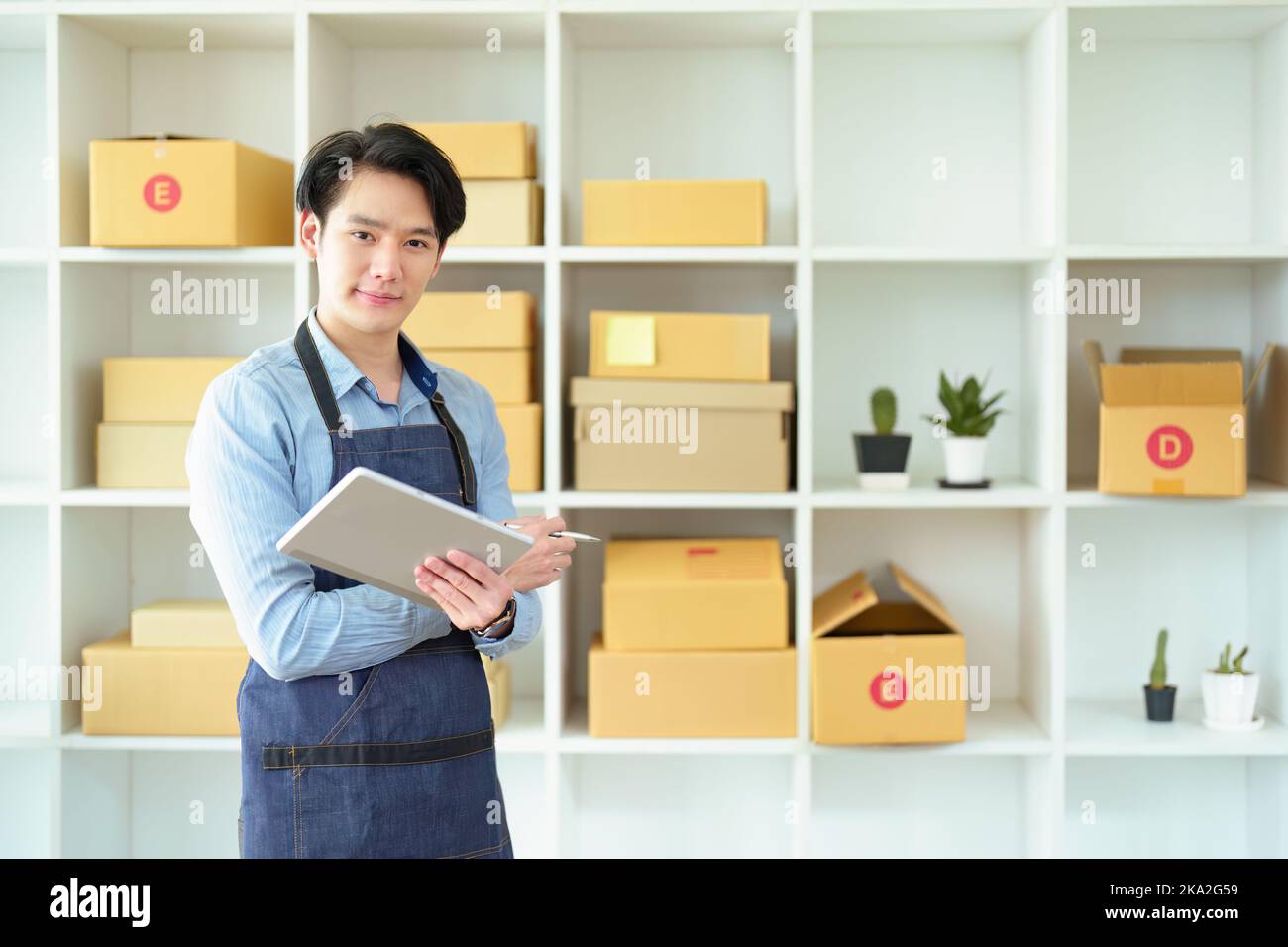 A portrait of a small start-up and SME owner, an Asian male ...