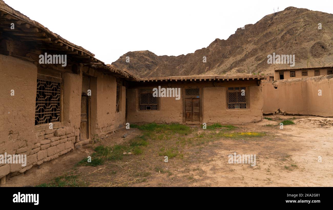 Old mud brick houses captured in a village with poor living conditions ...