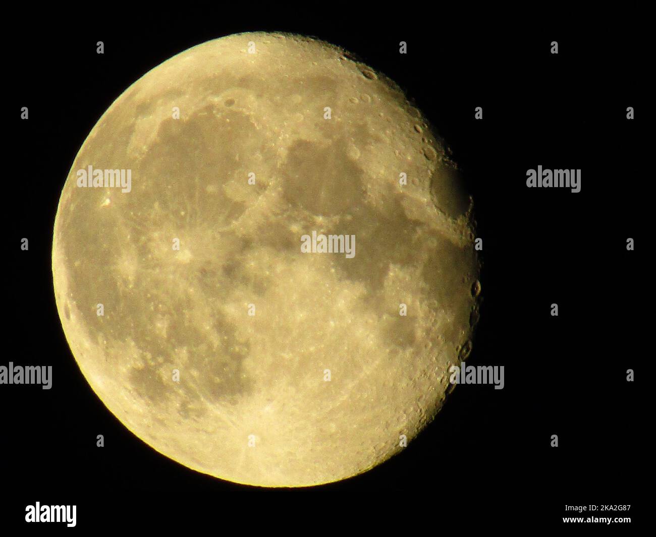 A closeup of a full moon surface against a black background Stock Photo ...