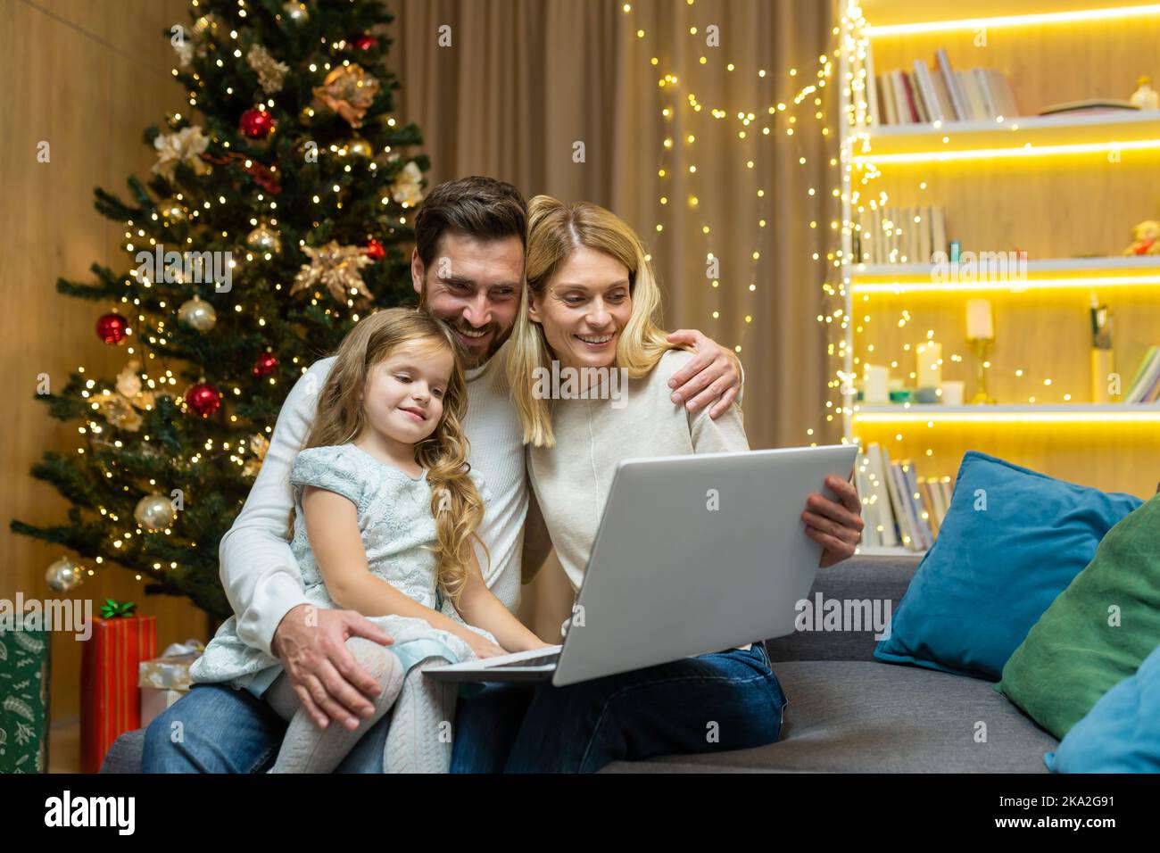 mature parents teach their child to use a laptop studying learning ...