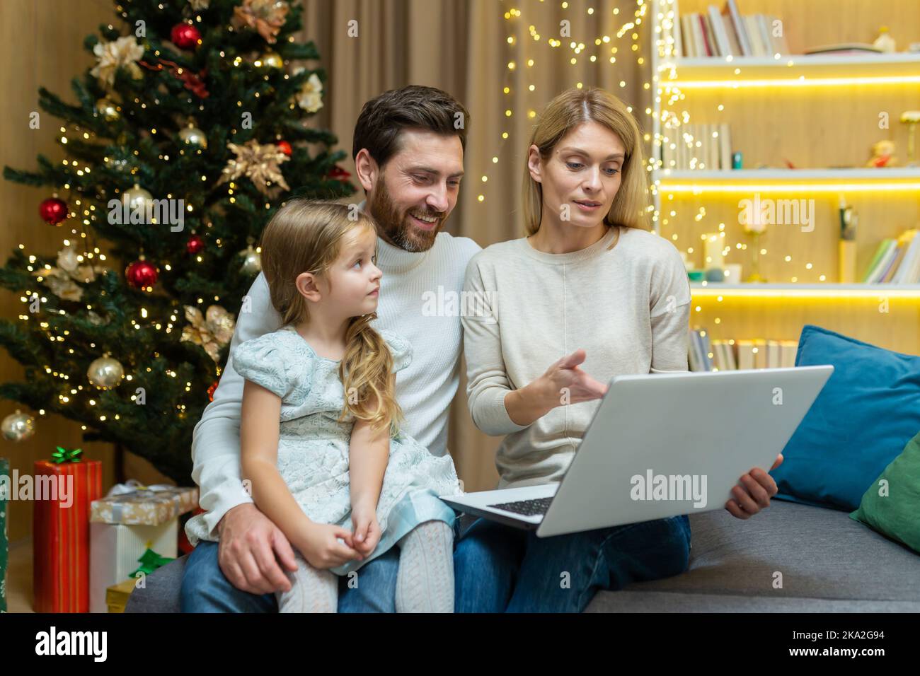 mature parents teach their child to use a laptop studying learning ...
