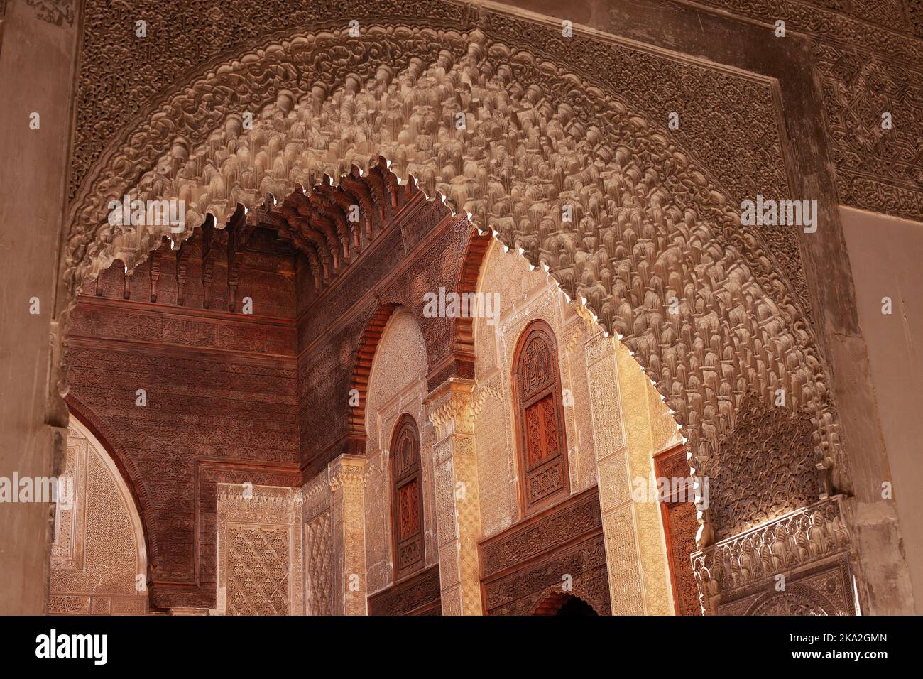 A view of an orange building's interior arch of the Al-Attarine Madrasa ...