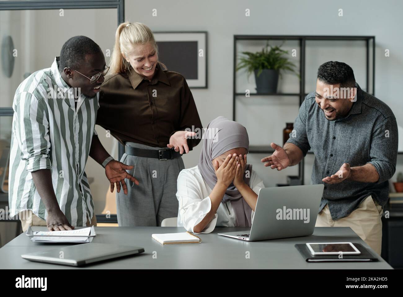 Group of cruel young multicultural classmates making fun of girl in ...