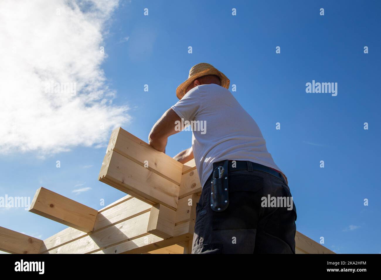 Wood construction: Carpenters assembling a garden sauna Stock Photo - Alamy