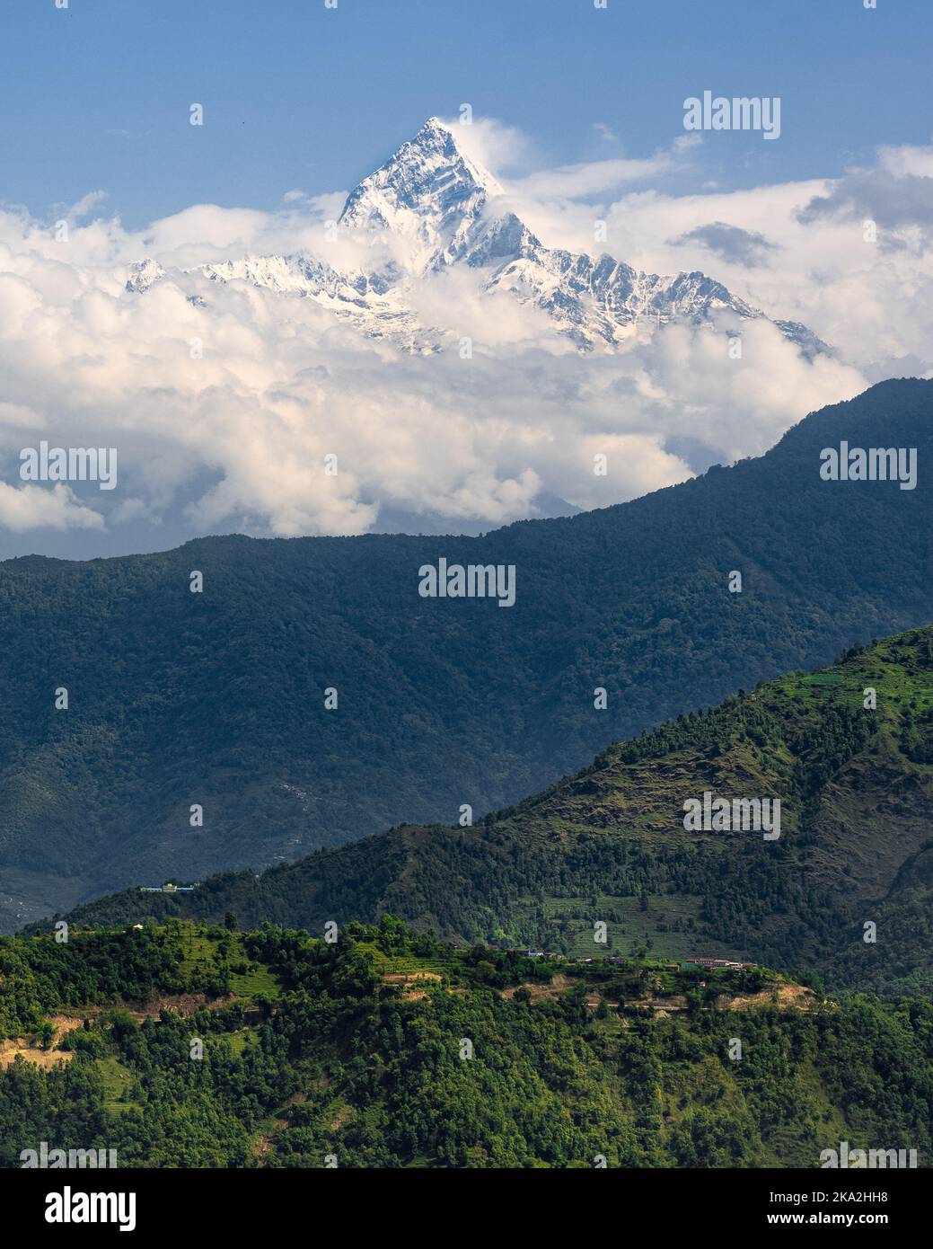 The Machapuchare AKA Fishtail Mountain snowy peak and the green hills, Himalaya Range, Nepal ...