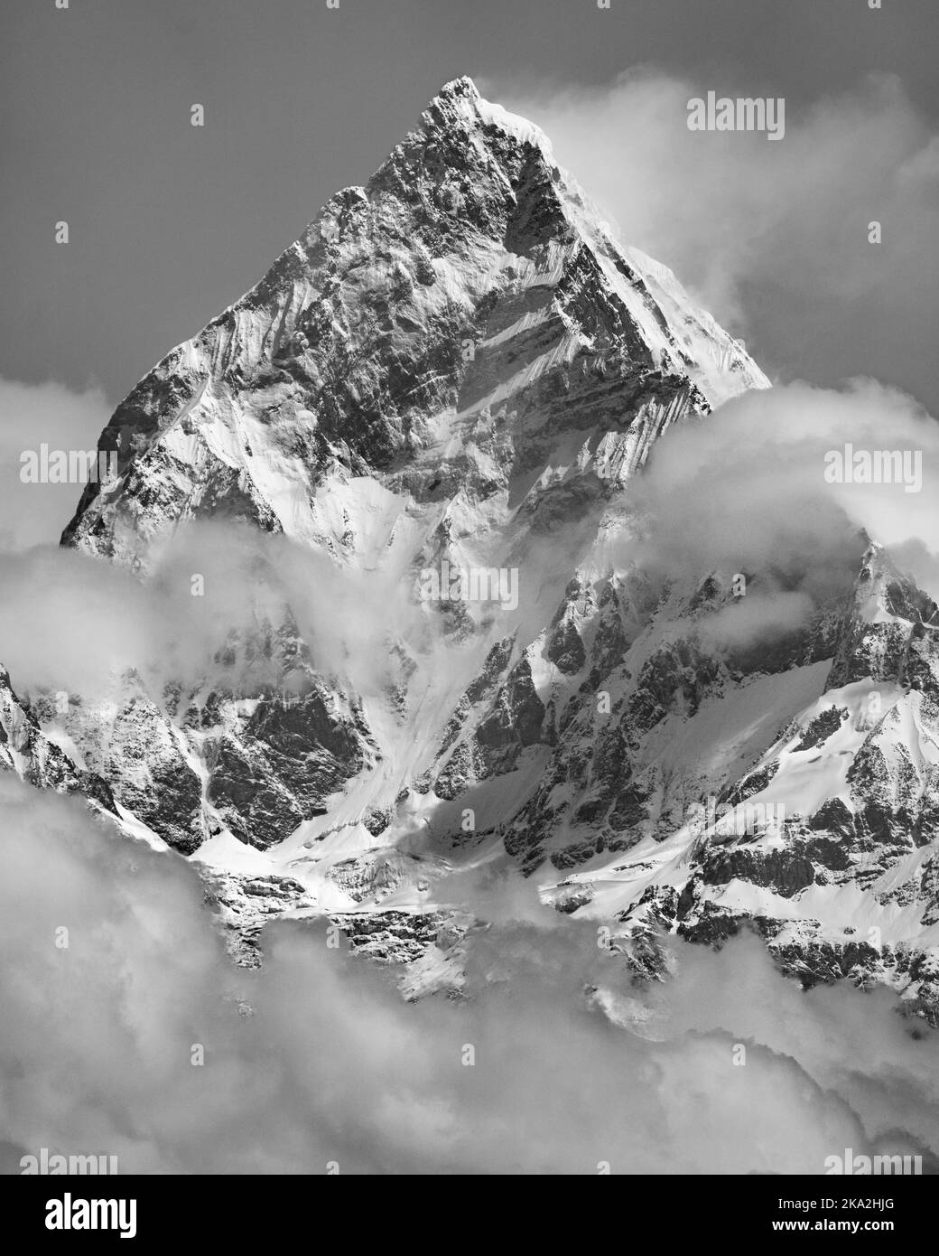 A grayscale shot of Machapuchare AKA Fishtail Mountain snowy peak ...