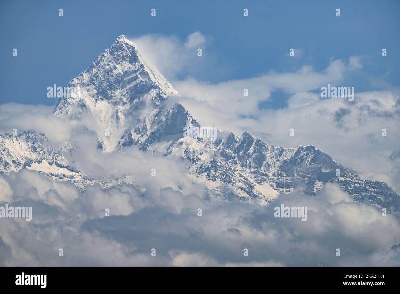 The Machapuchare AKA Fishtail Mountain snowy peak covered with clouds ...