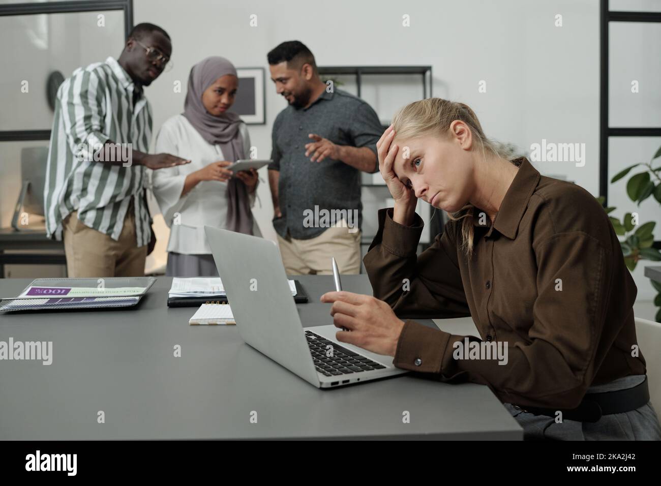 Young tired businesswoman trying to concentrate during work over ...