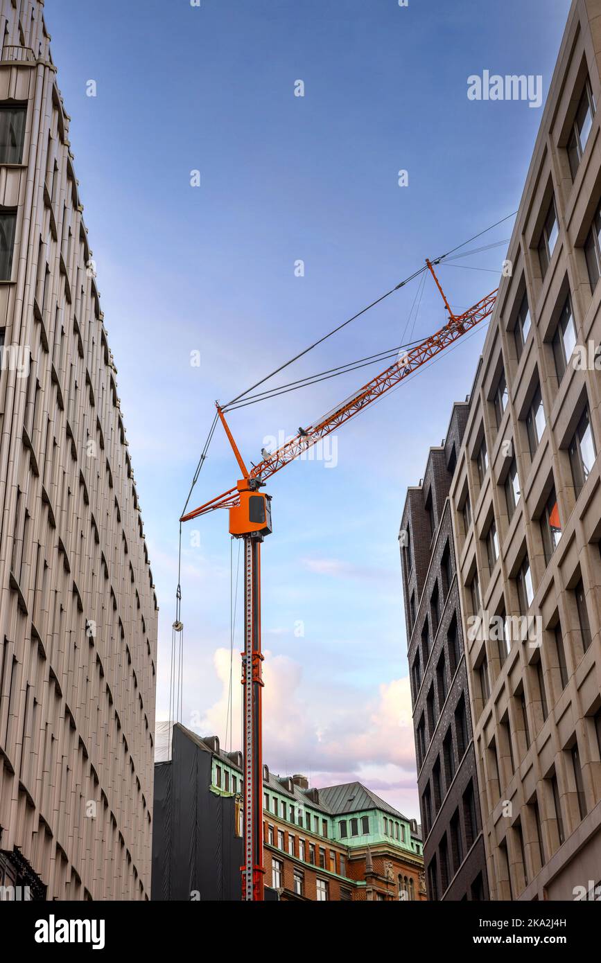 Building work stopped with large orange crane in city centre apartment ...