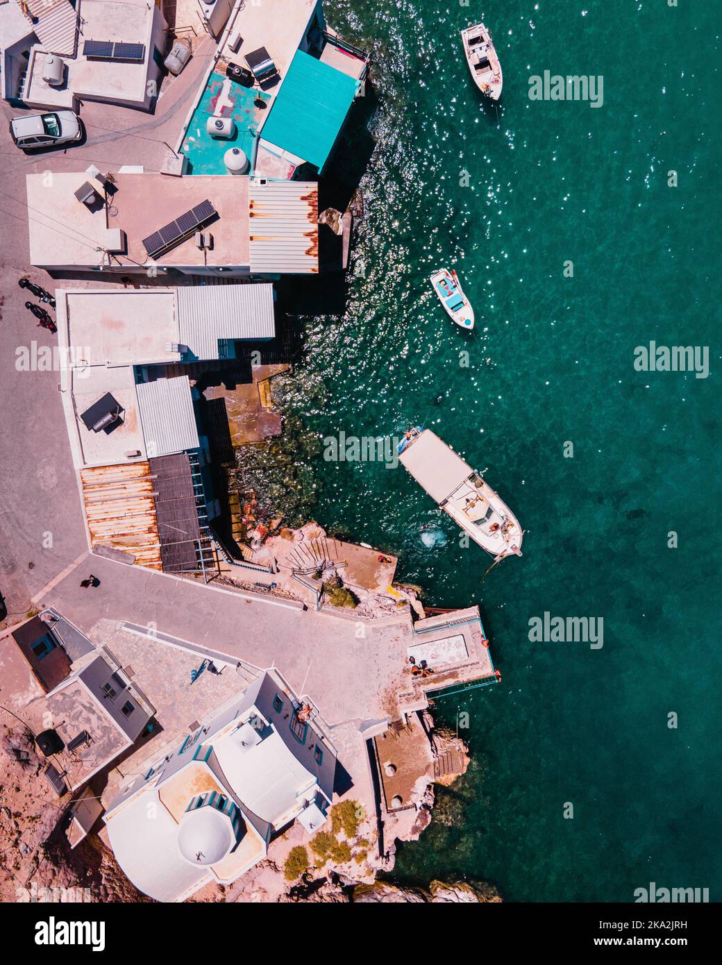 An aerial view of coastal town in Milos island in Greece on a sunny day ...