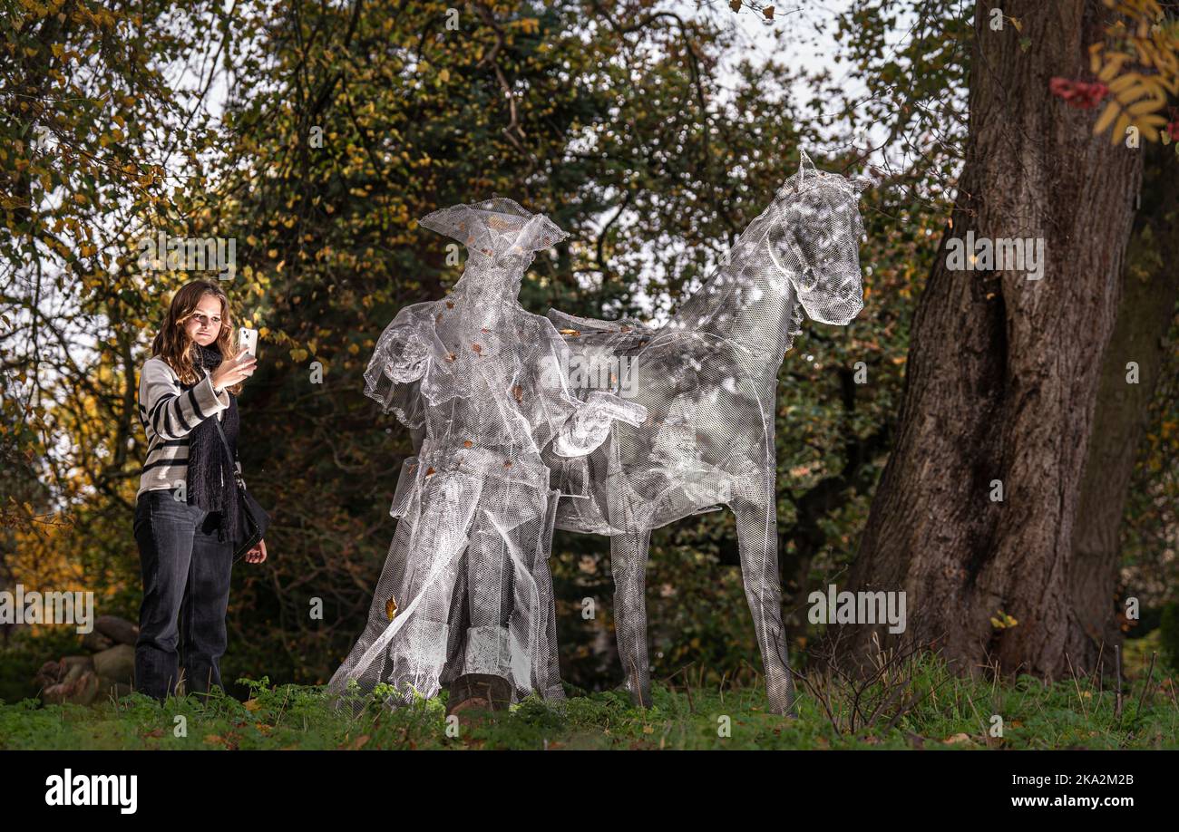 Eva Deprez takes a photograph of 'Highwayman and Horse' that forms part ...