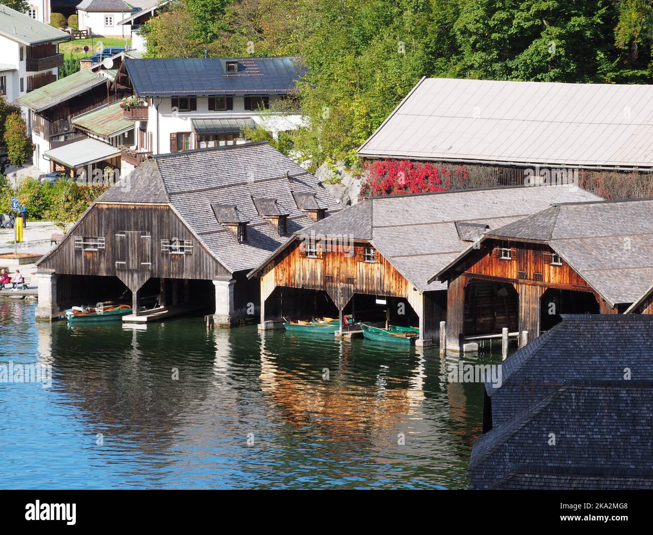 An aerial view of old wooden boathouses on water in Koenigsee Stock ...