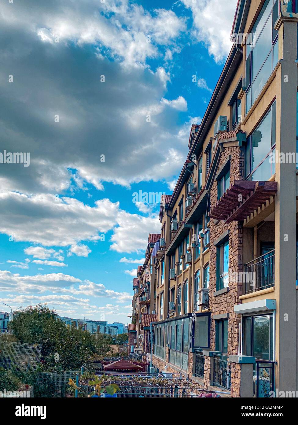 A vertical shot of a residential building under a cloudy sky Stock ...