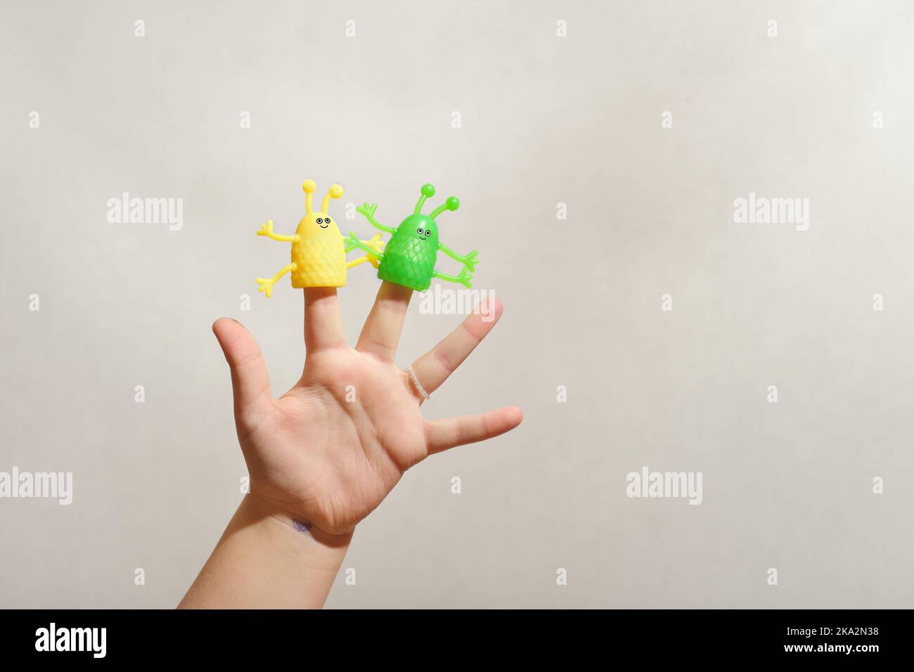two fingers wearing puppets aliens. Kid playing fingers puppets. Finger ...