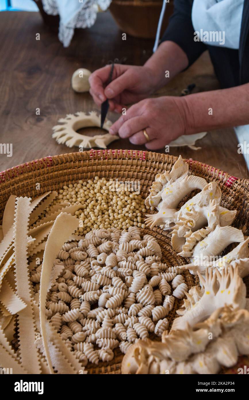 Typical sardinian homemade products: pasta and decorated bread for ...