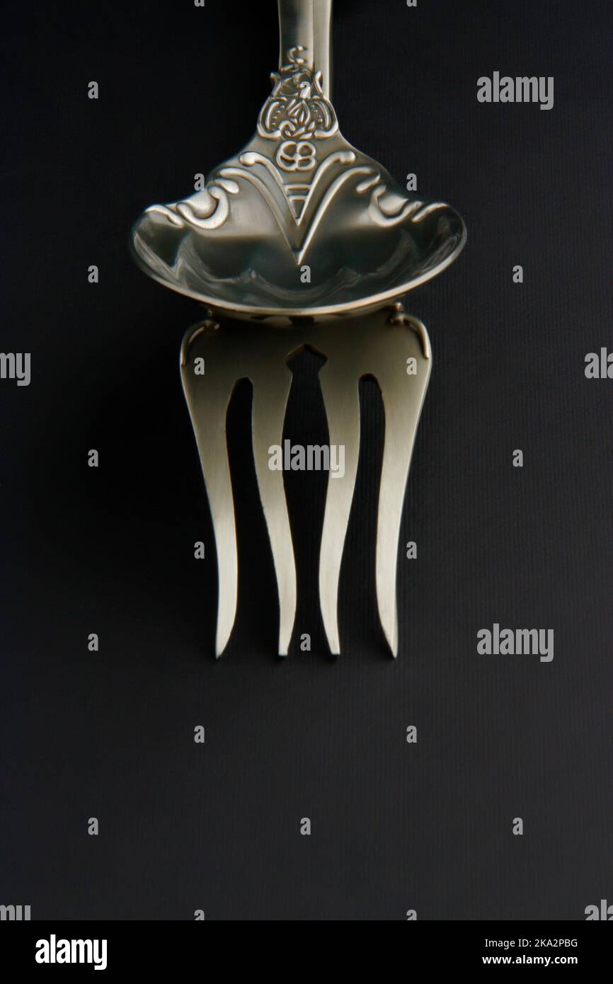 Set of traditional spoon and fork on the black background. Promotional ...