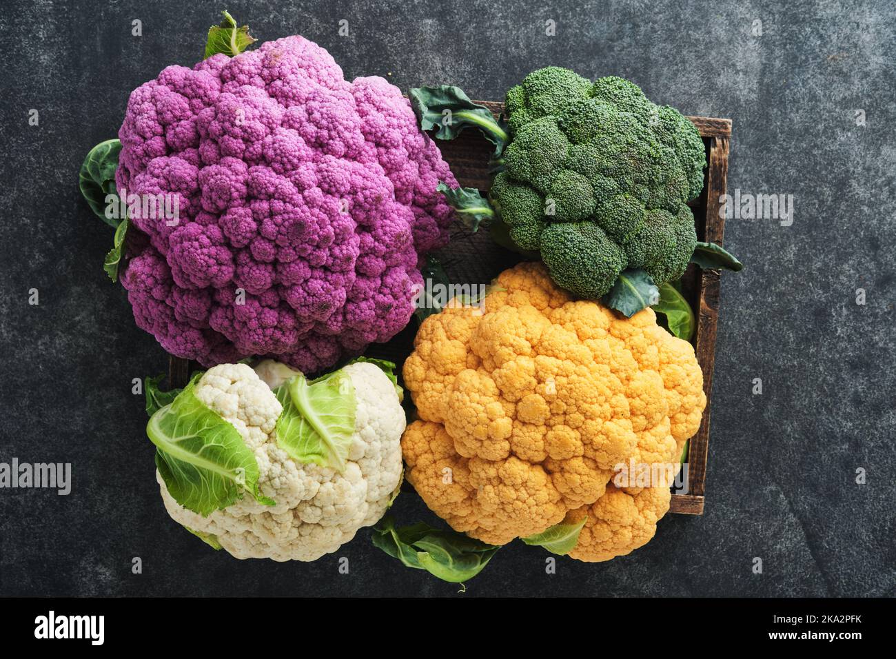 Colorful cauliflower. Various sort of cauliflower on old dark gray ...