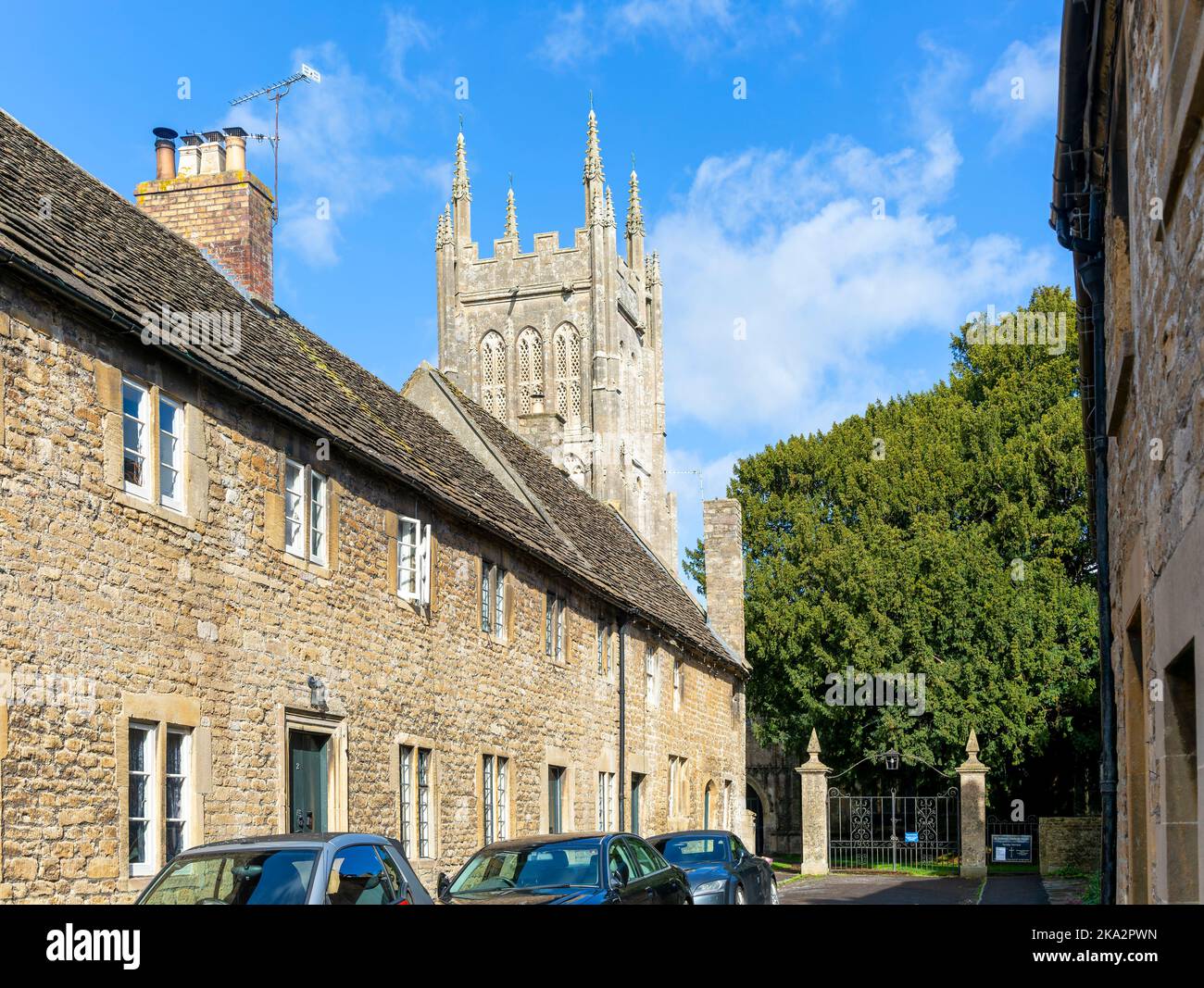 Church tower and historic cottages in New Street, Mells, Somerset ...