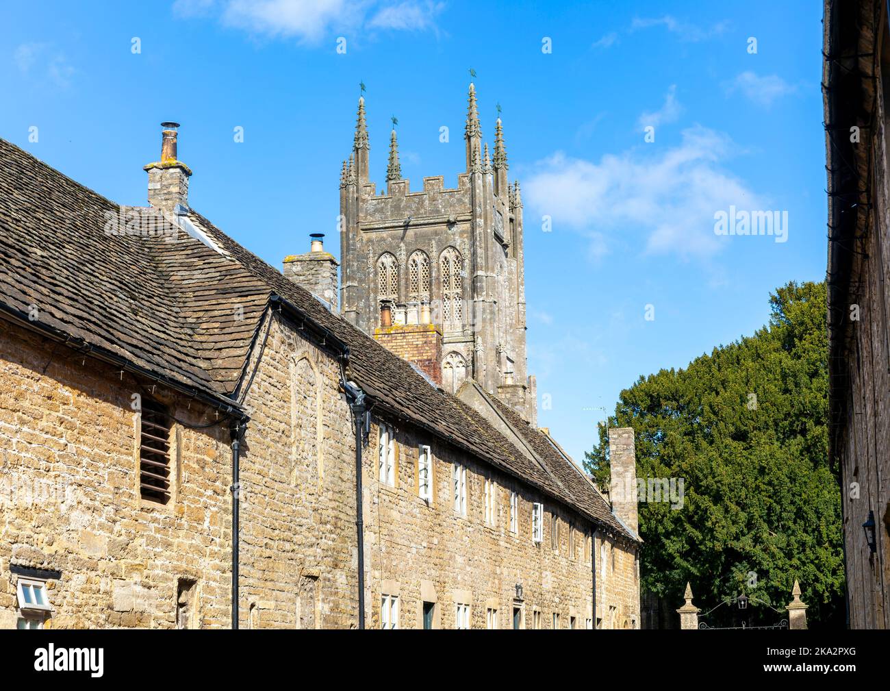 Church tower and historic cottages in New Street, Mells, Somerset ...