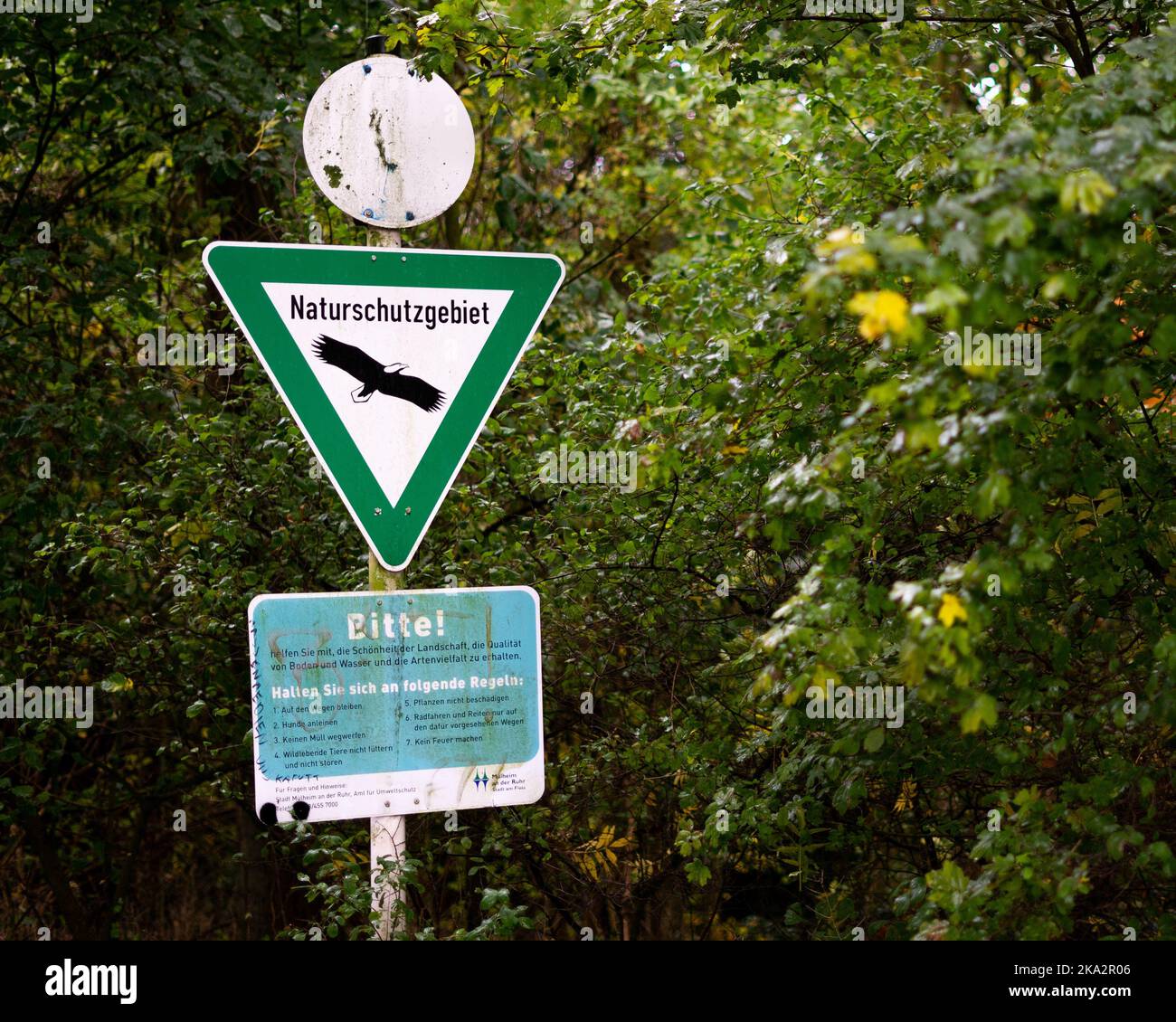 A nature and wildlife protection green triangular sign and plaque on ...