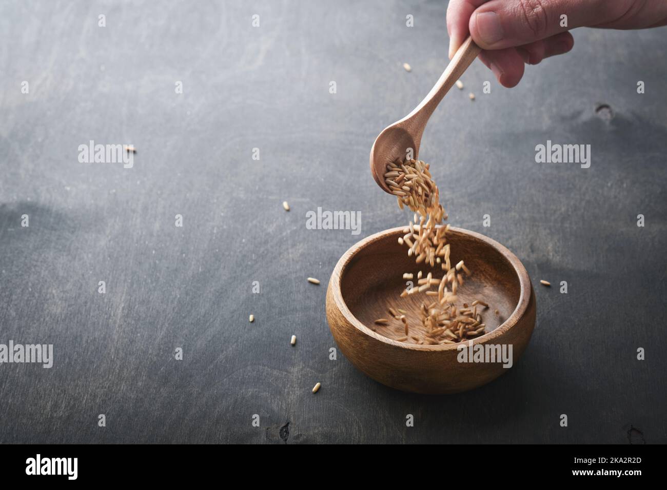 World food crisis concept. Male hands applies very small amount of ...