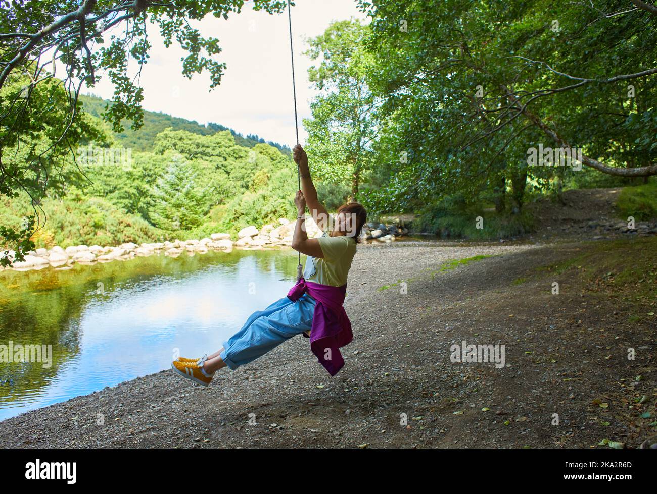 Jump into the water. A woman is resting on the lake. A swing from a ...