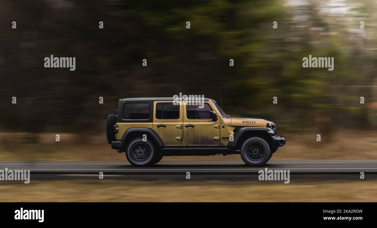 The view of the jeep driving fast on a country road Stock Photo - Alamy