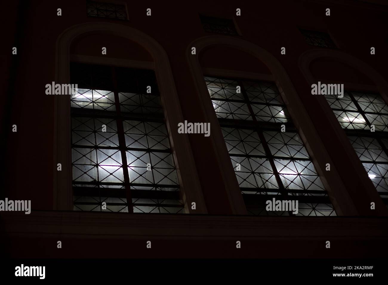 Windows at night. Light in windows in evening. Building outside in dark ...