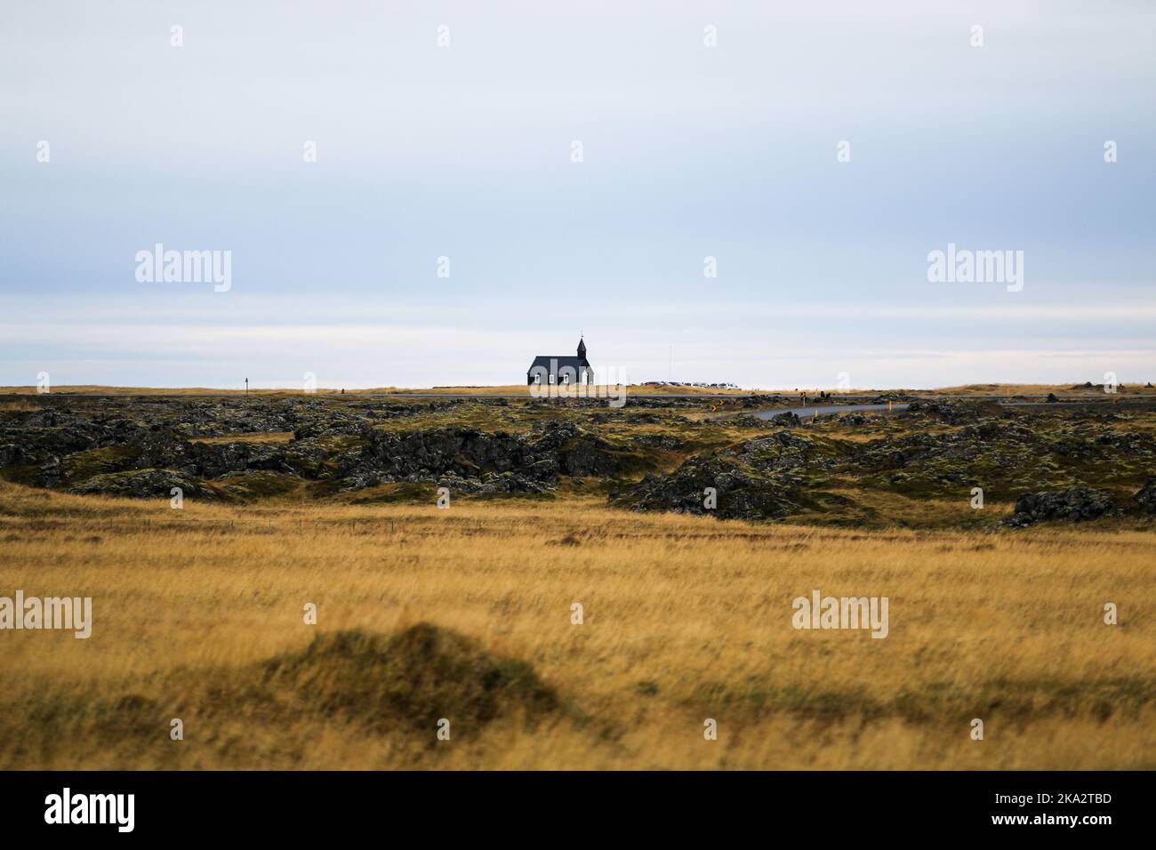 A minimalistic landscape of an isolated black church in the countryside ...