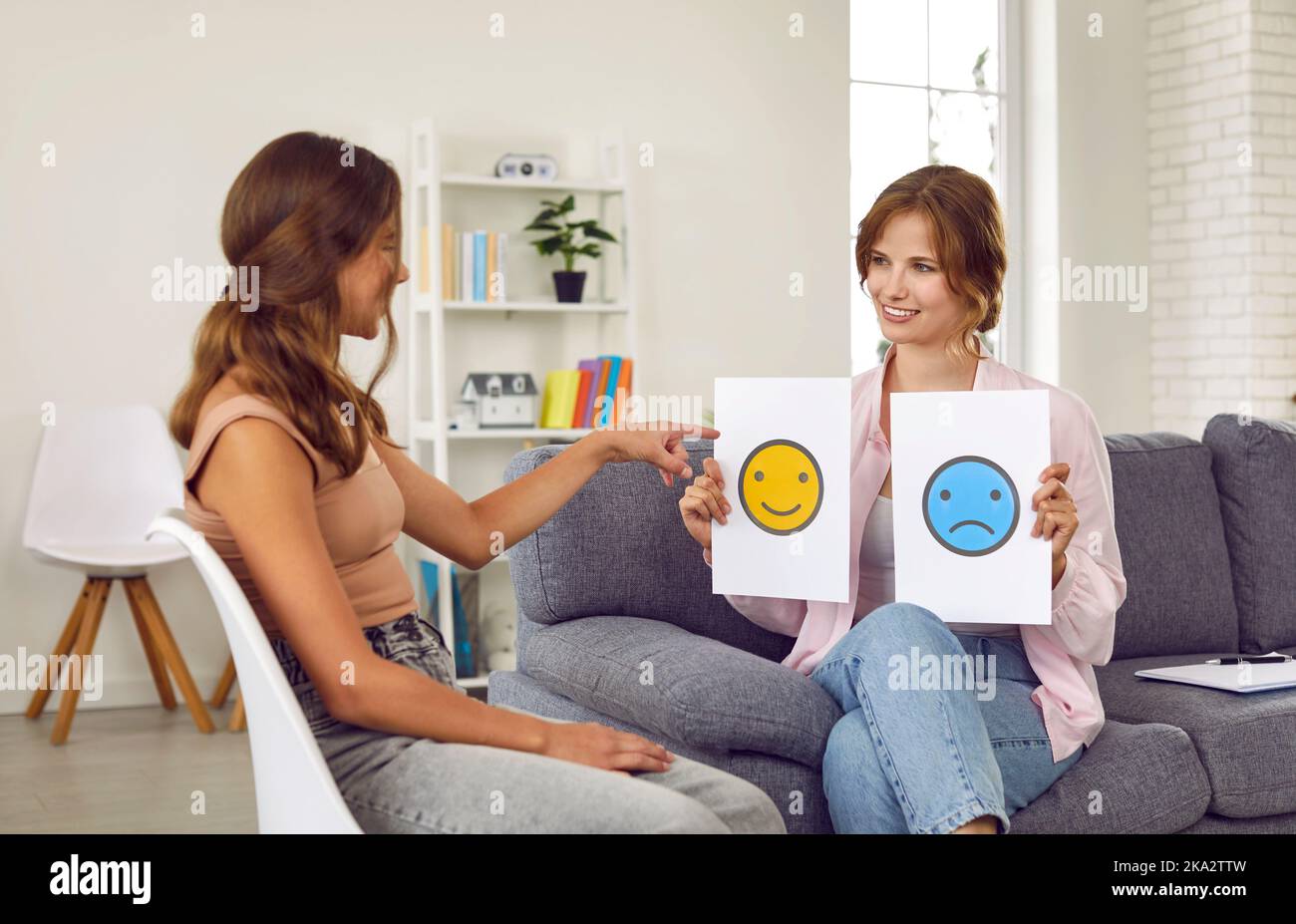 Friendly female child psychologist talks to teenage girl about emotions ...