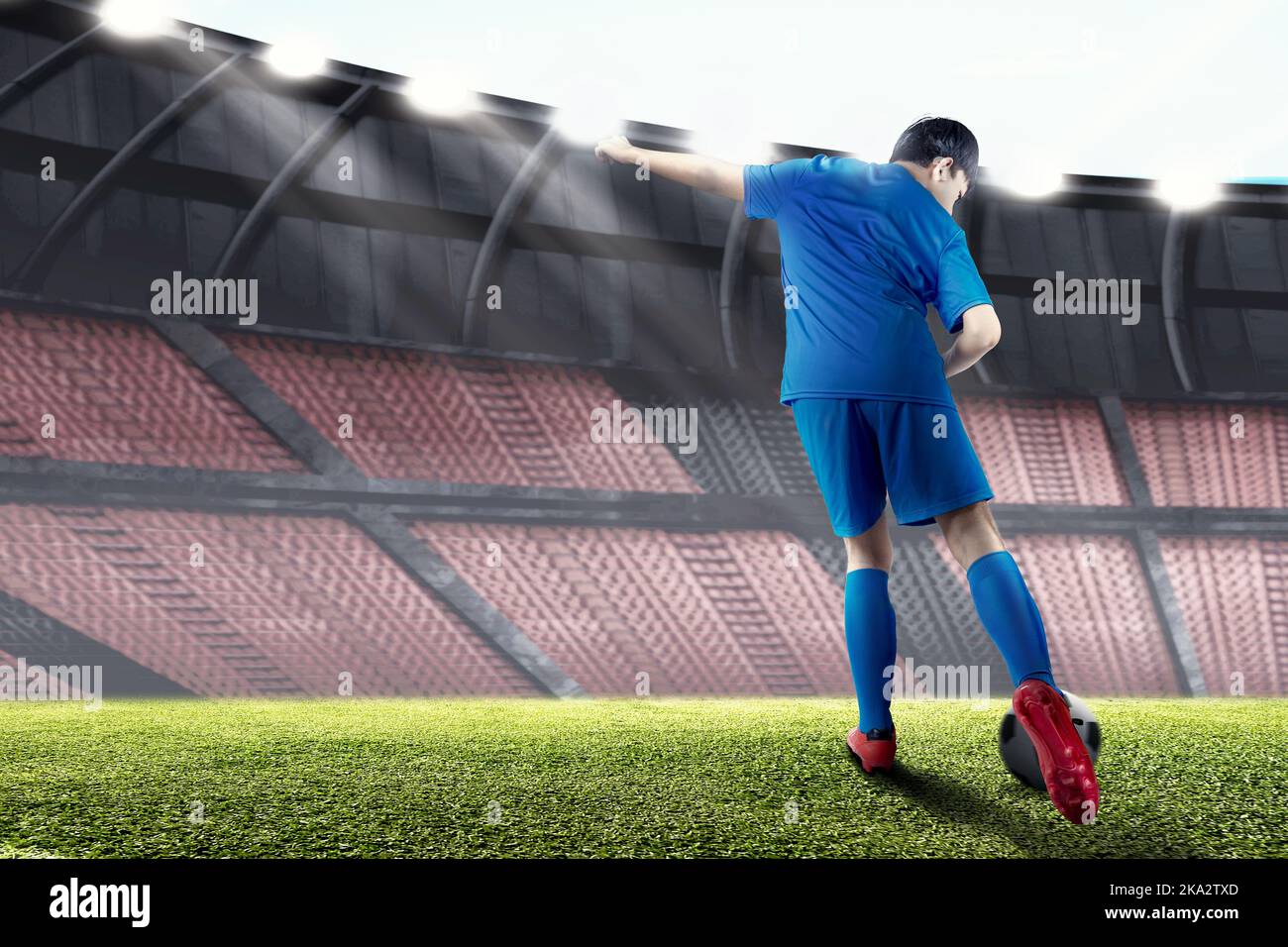 Rear view man kick ball hi-res stock photography and images - Alamy