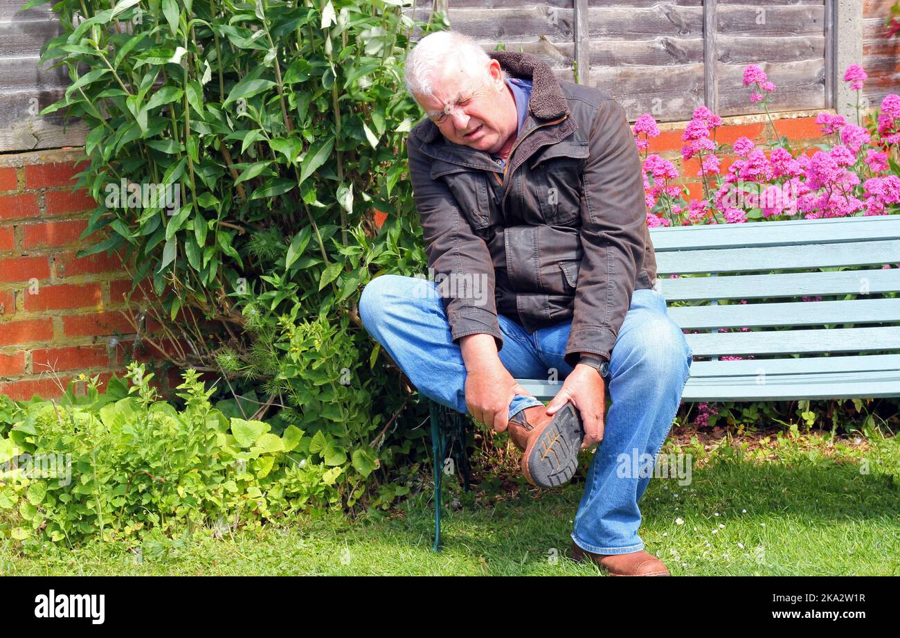 Elderly or old man with foot pain. Either injury by accident of ...