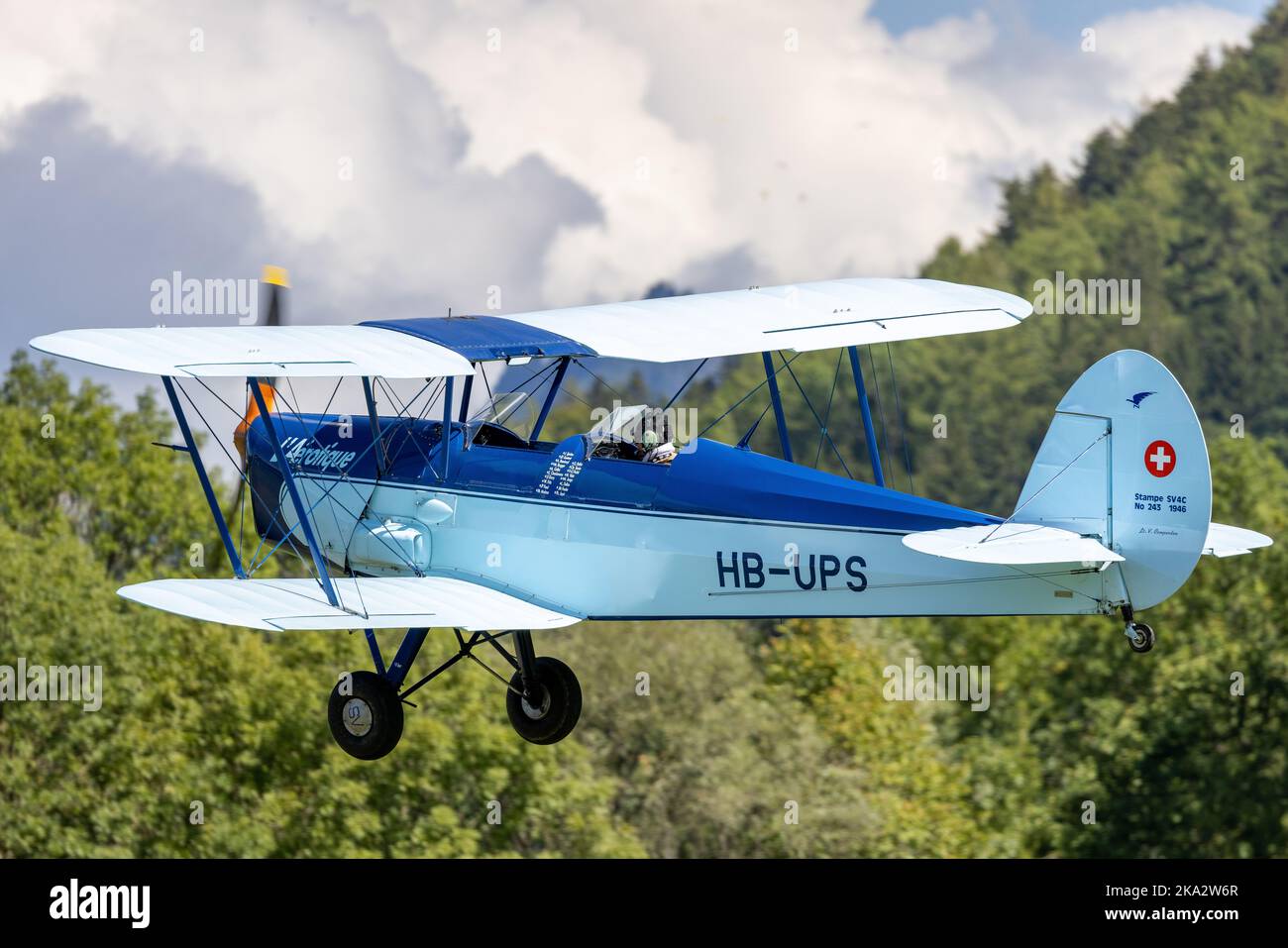 A view of the Gipsy Moth HB-UPS aircraft flying over the trees in ...
