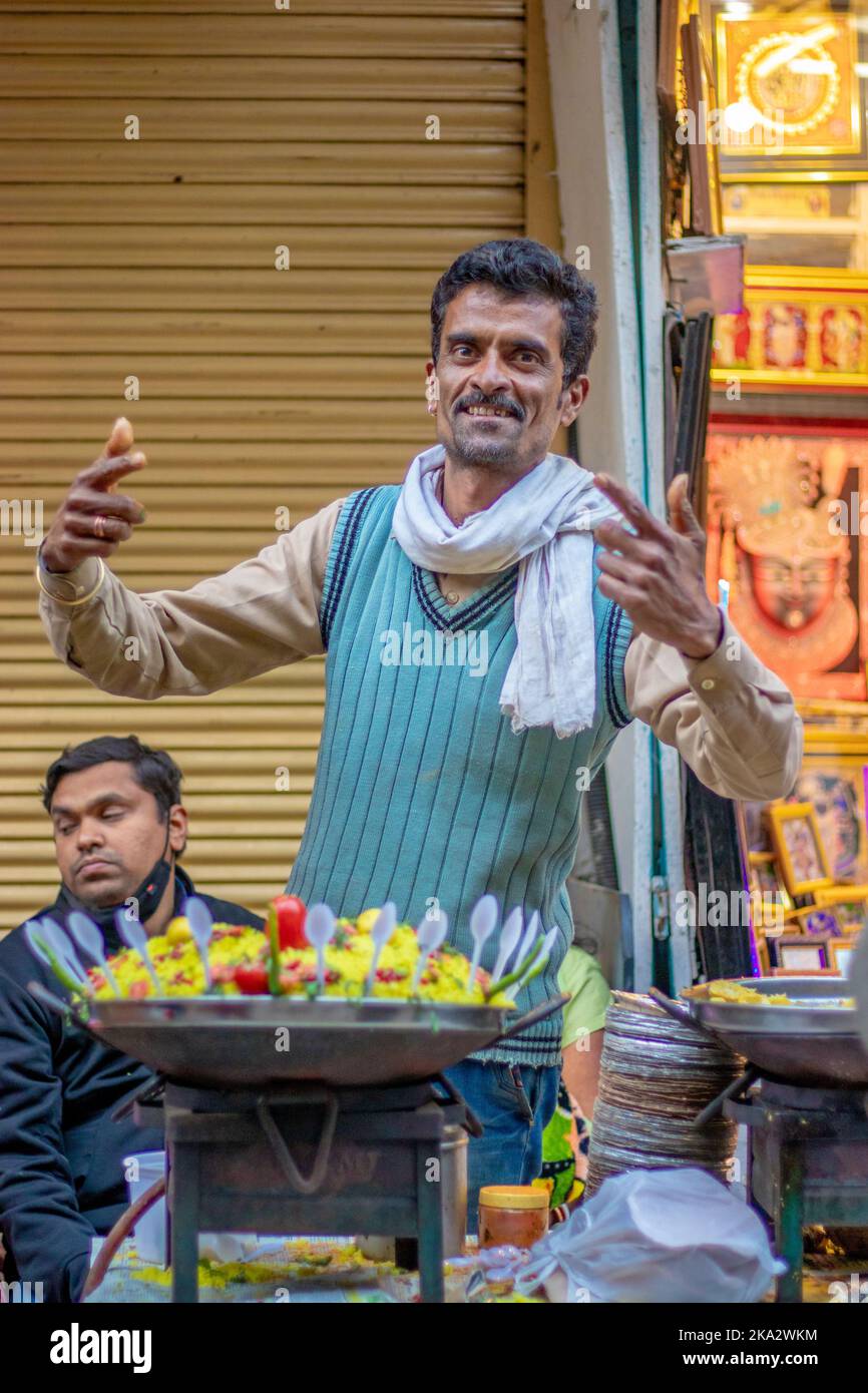 A vertical shot of a salesman at a local street market in India Stock ...