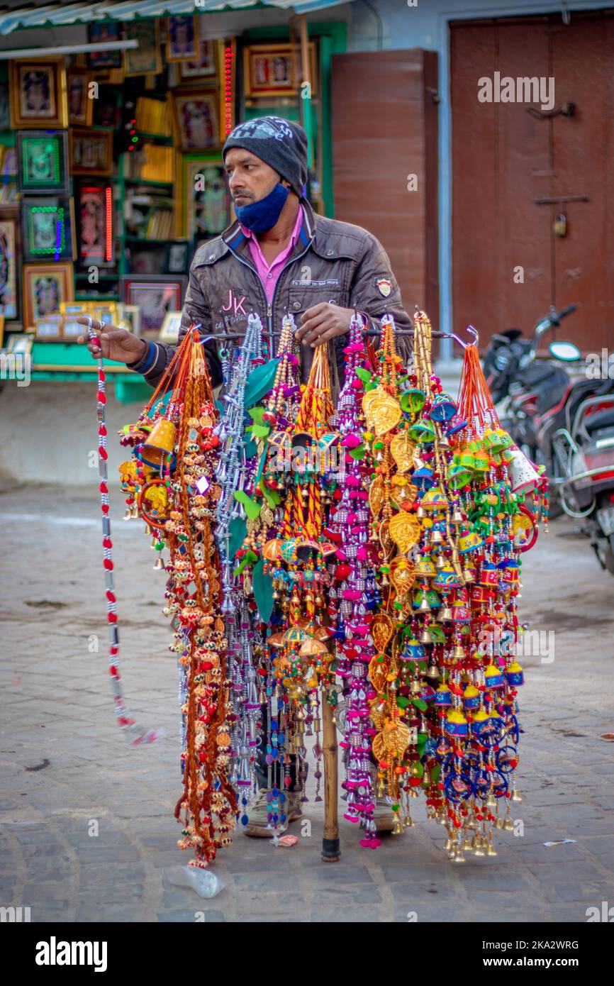 A vertical shot of a salesman at a local street market in India Stock ...