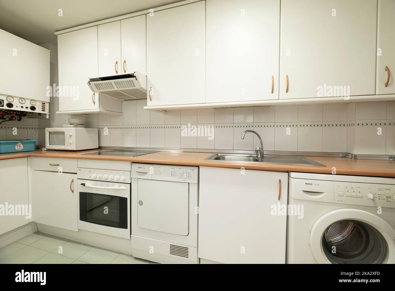 elongated kitchen room with white cabinets with matching appliances ...