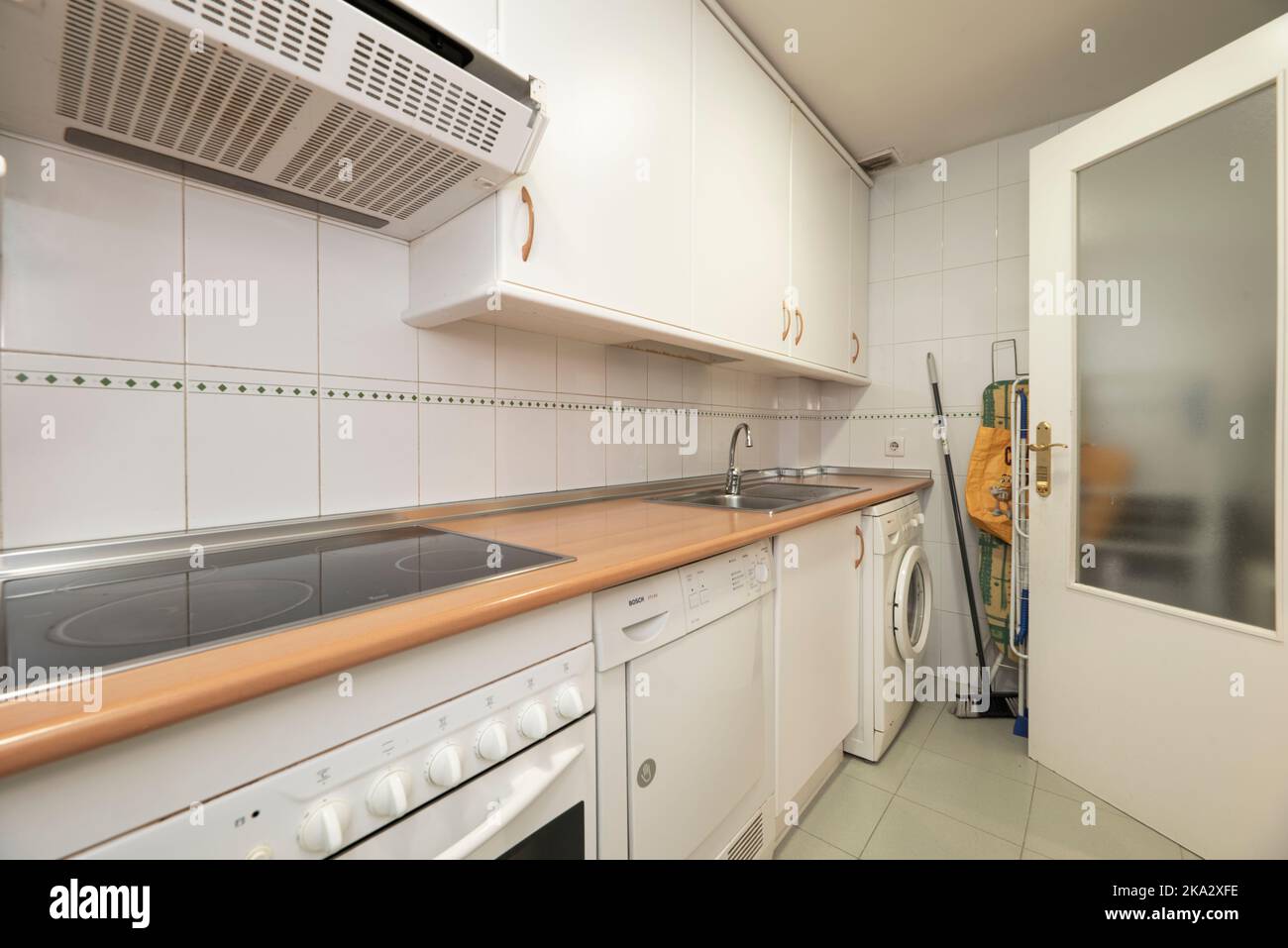 elongated kitchen room with white cabinets with matching appliances ...