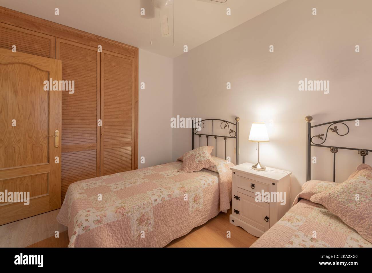 Bedroom with double beds with bedspreads and twin headboards and a ...