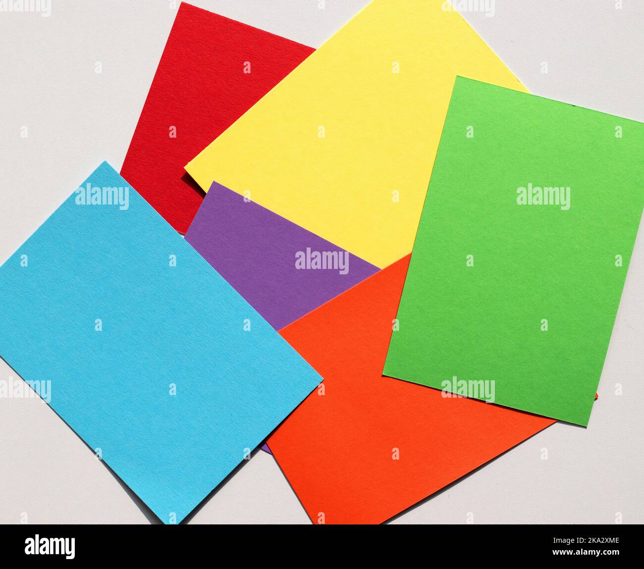 A top view of colorful papers on a white background Stock Photo - Alamy