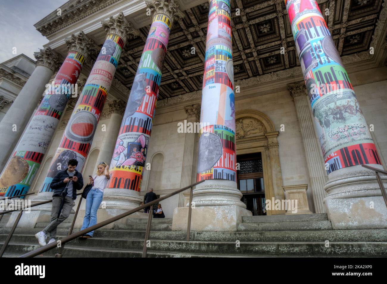 Young male and female couple on steps of fitzwilliam museum cambridge ...