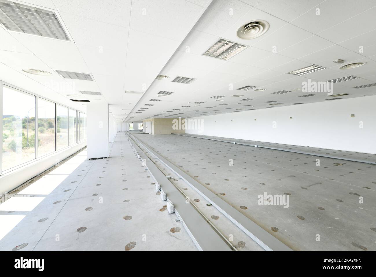 large elongated office building with large window and awaiting ...