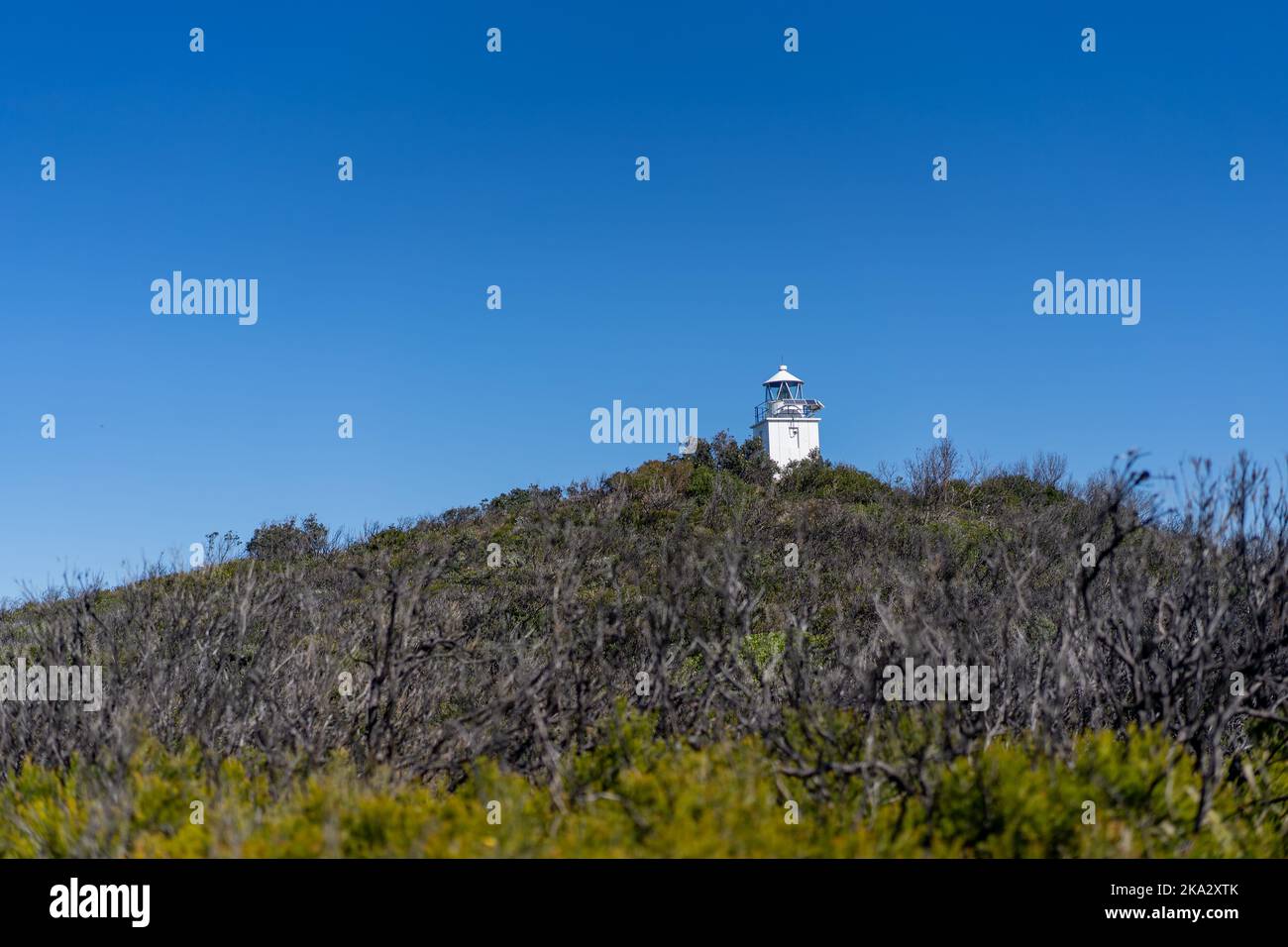 A beautiful view of a lighthouse on a hill with a beautiful blue sky in ...