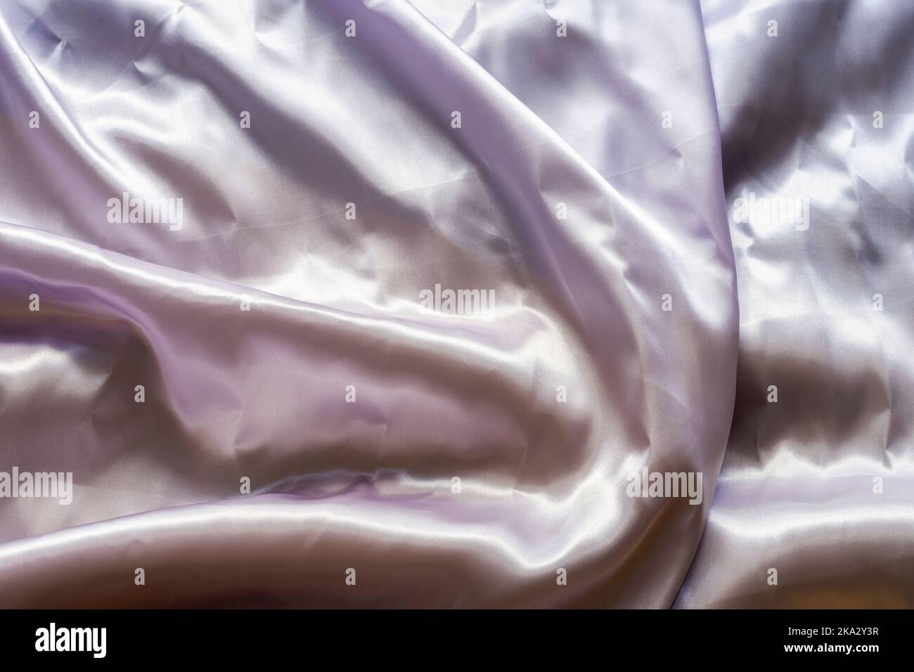 satin fabric background of a pearly pinkish tone with water and ...